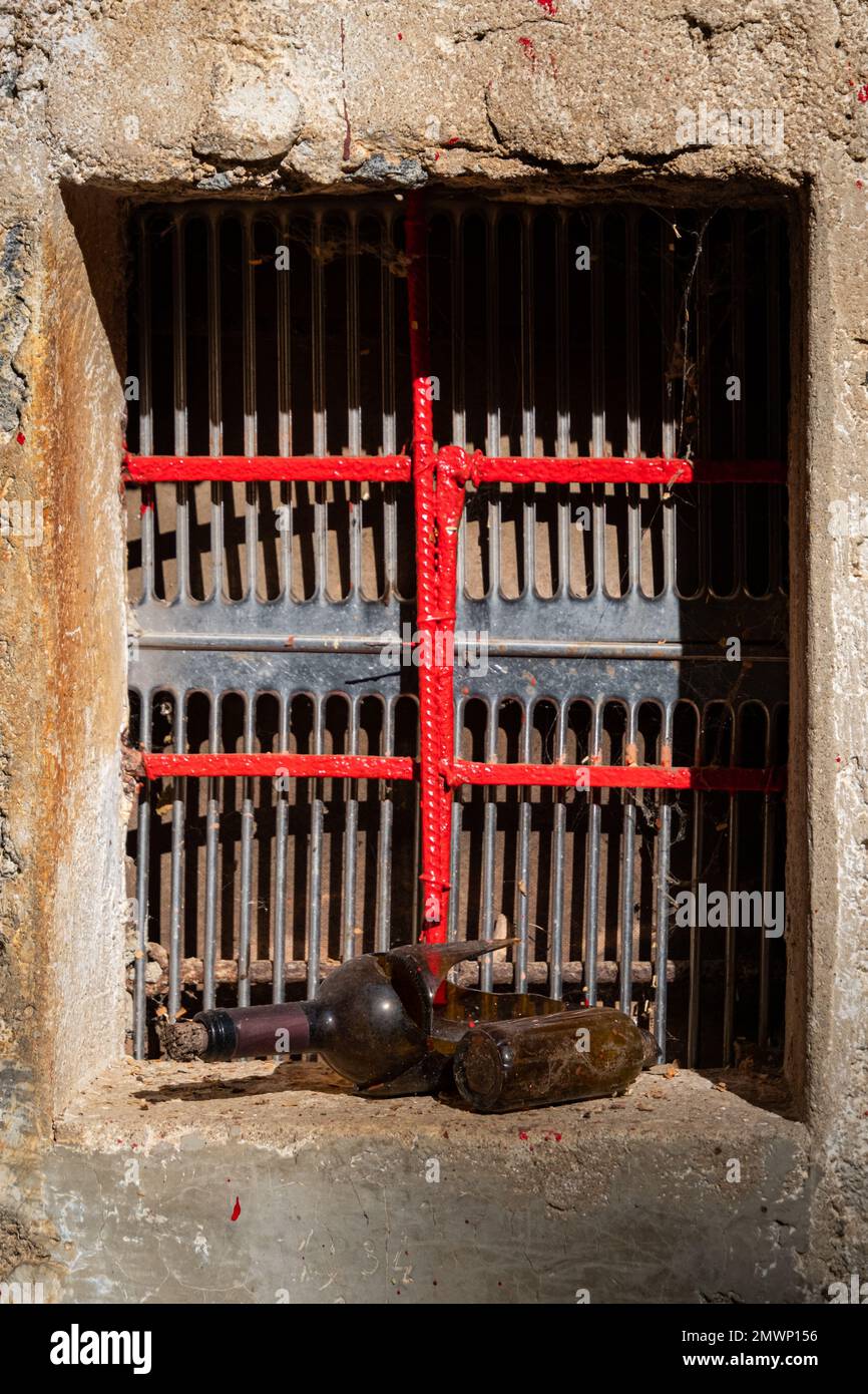A barred window and a broken bottle on the sill Stock Photo - Alamy