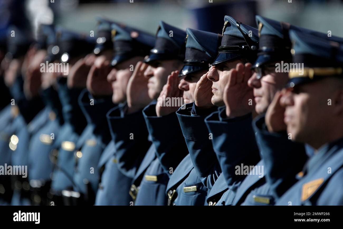 New Jersey State Police officers salute prior to an NFL football game ...