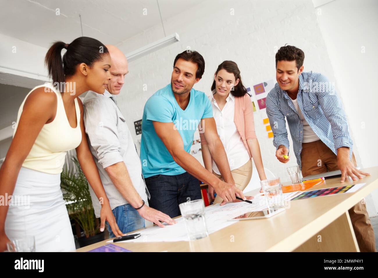 Positive about their project. A group of designers gathered together ...