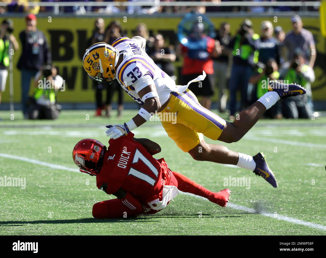 Louisville wide receiver James Quick (17) is stopped by LSU safety ...