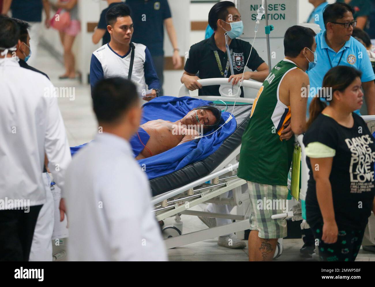 A man awaits treatment following a firecracker-related injury at a ...