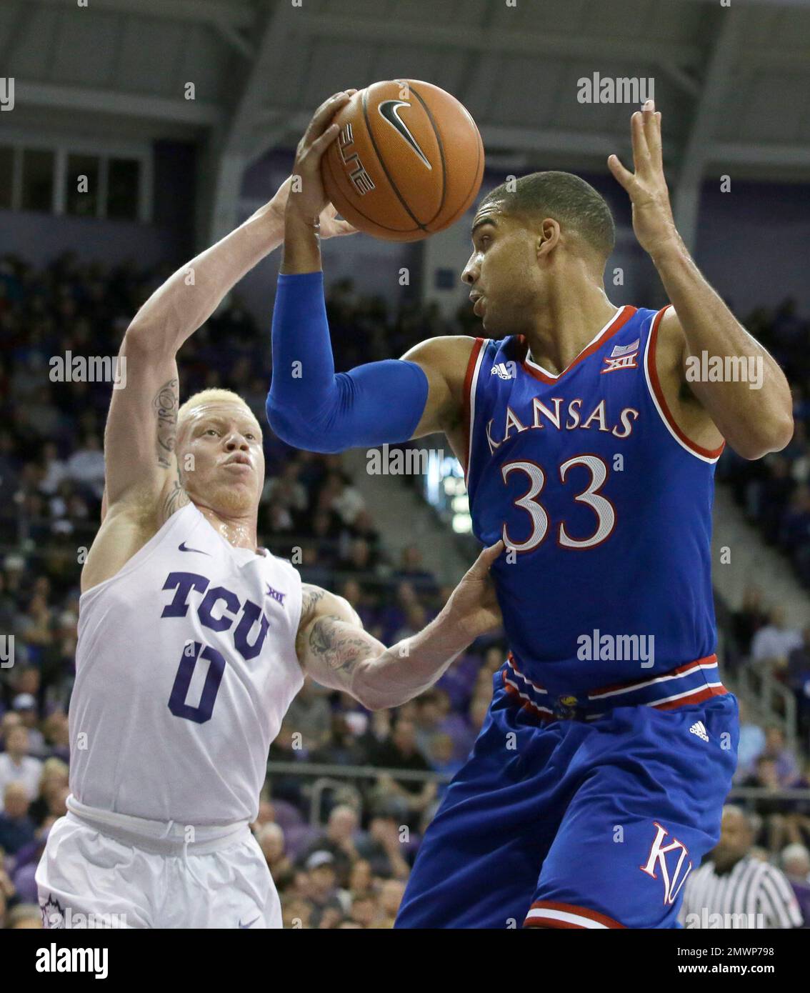 Kansas forward Landen Lucas (33) drives against TCU guard Jaylen Fisher ...