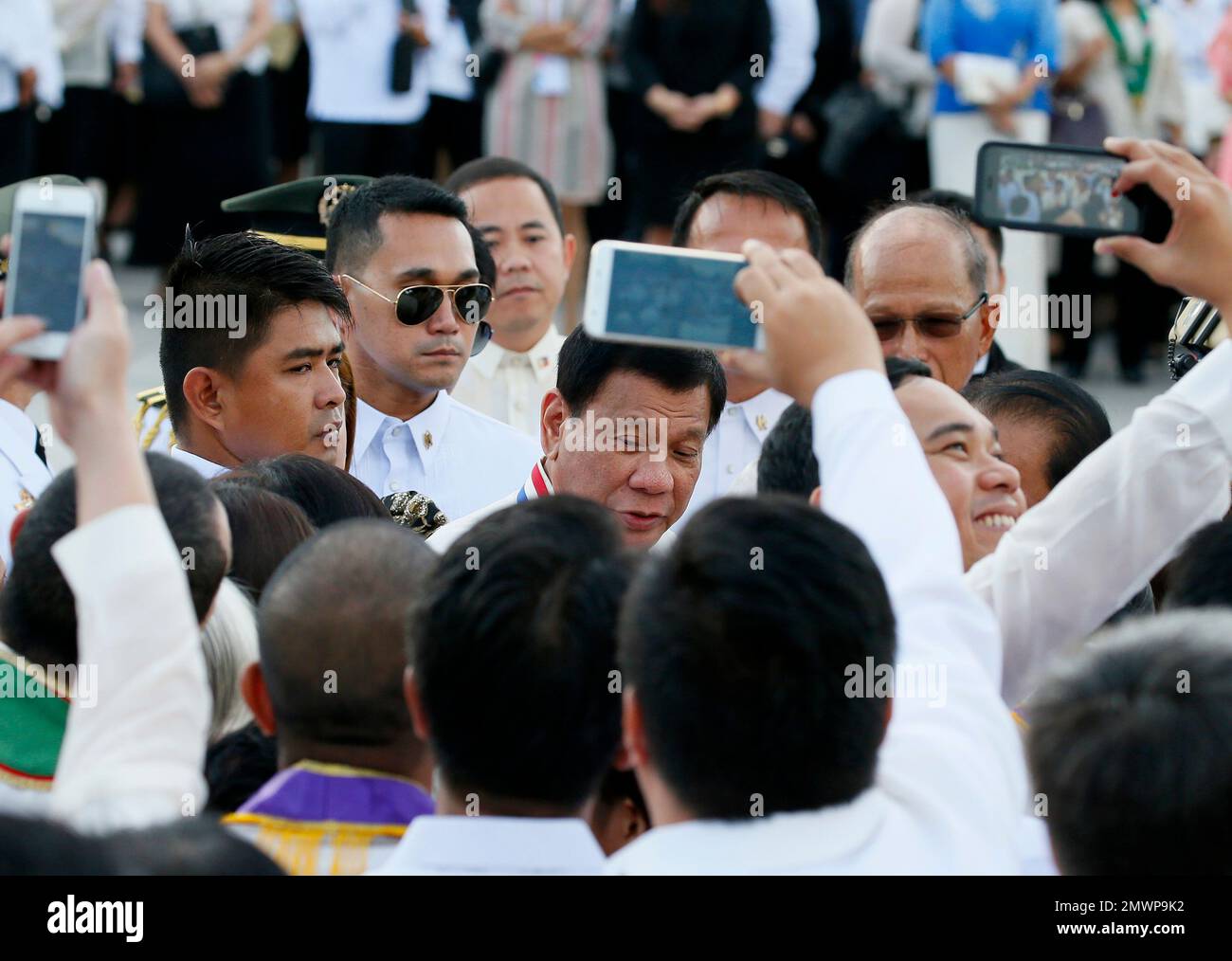 Philippine President Rodrigo Duterte, center, greets the crowd ...