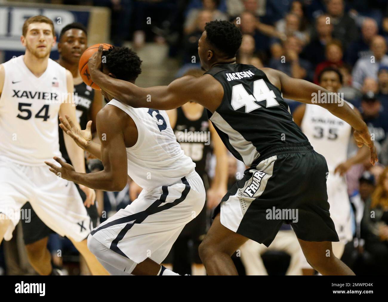 Providence guard Isaiah Jackson (44) kocks the ball away from Xavier ...