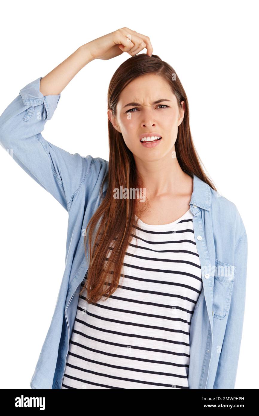 Who What where. Studio shot of a beautiful young woman scratching her ...