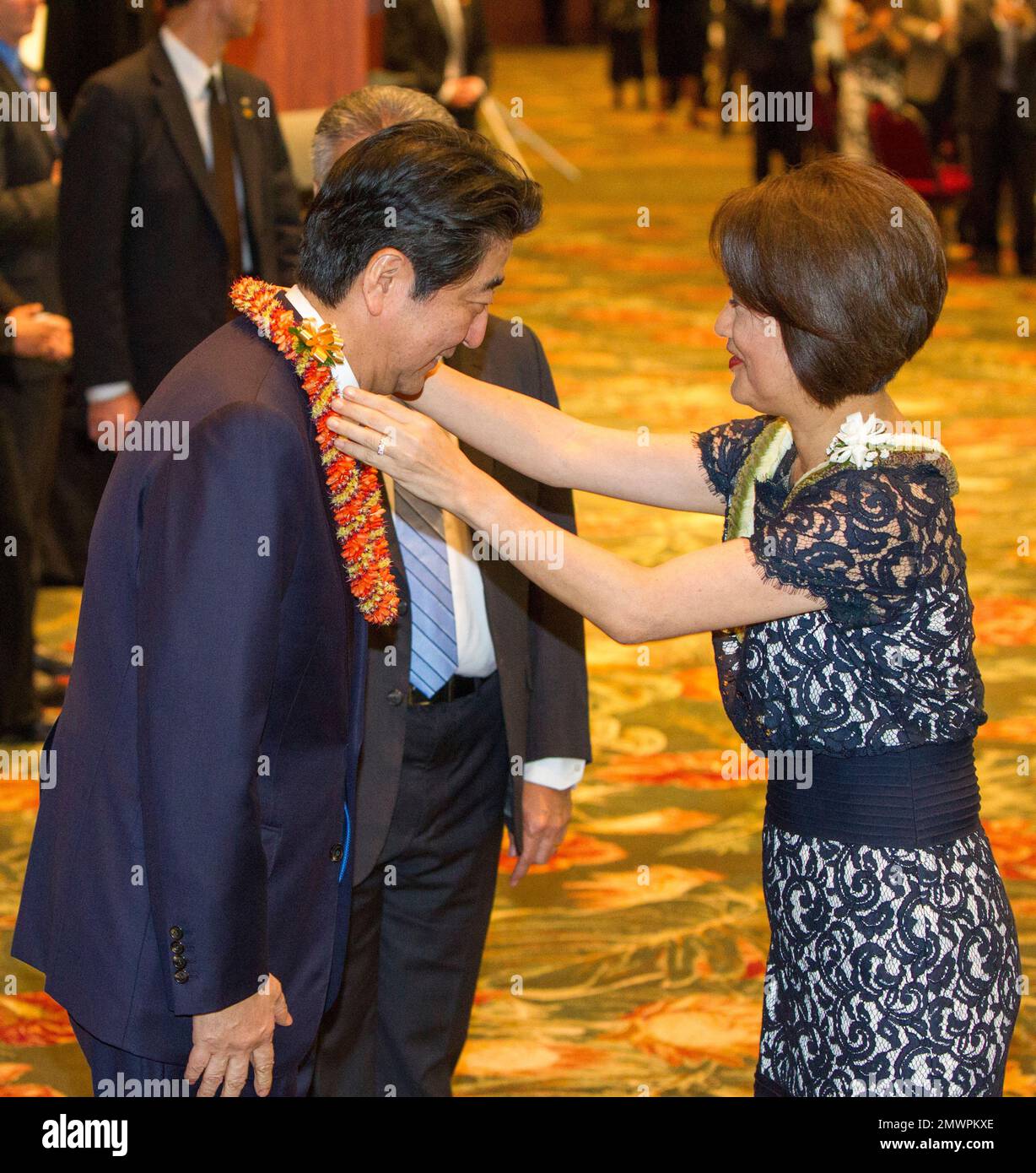 Japanese Prime Minister Shinzo Abe, left, is given a Hawaii flower lei ...
