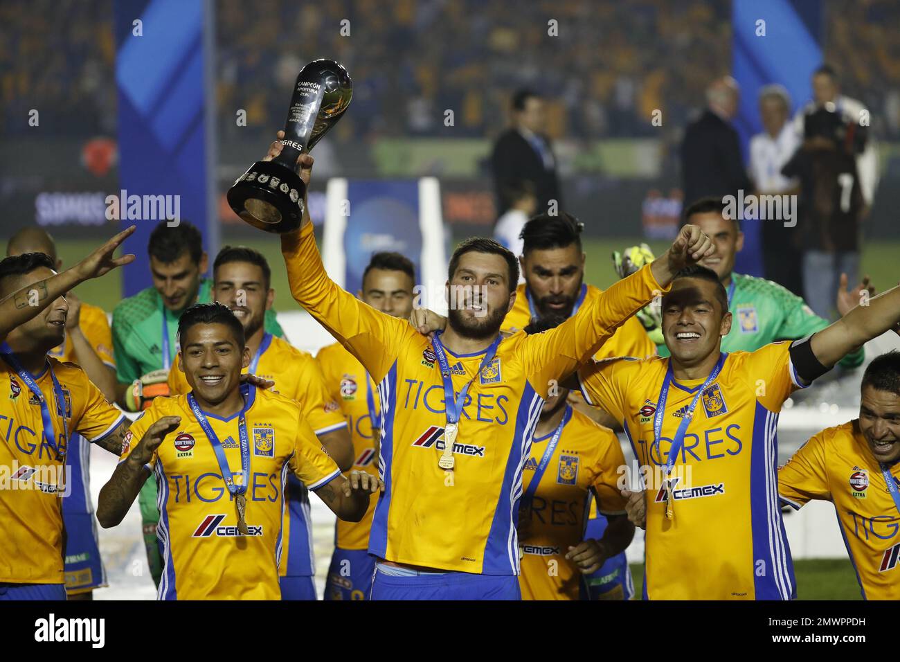 Tigres’ Andre Pierre Gignac, center, rises the trophy after defeating ...