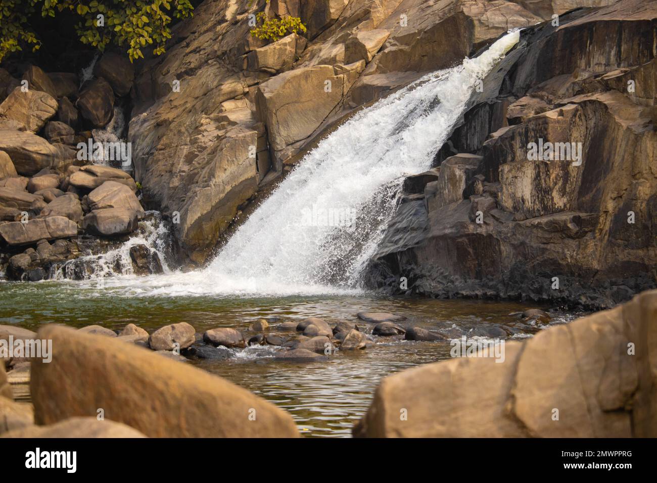 A short water fall flowing over rocks Stock Photo - Alamy