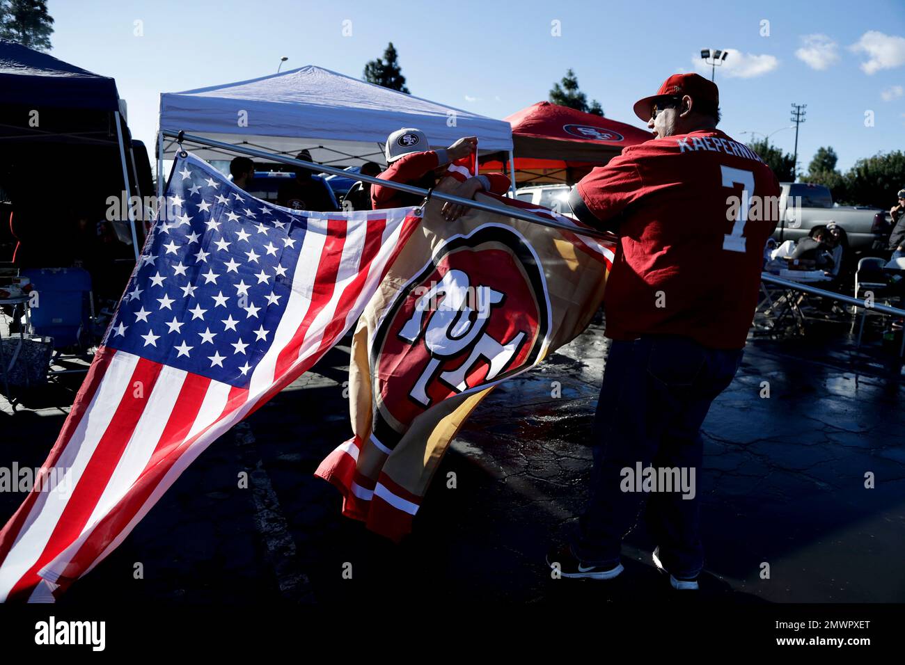 Tailgating fans set up before an NFL football game between the Los ...