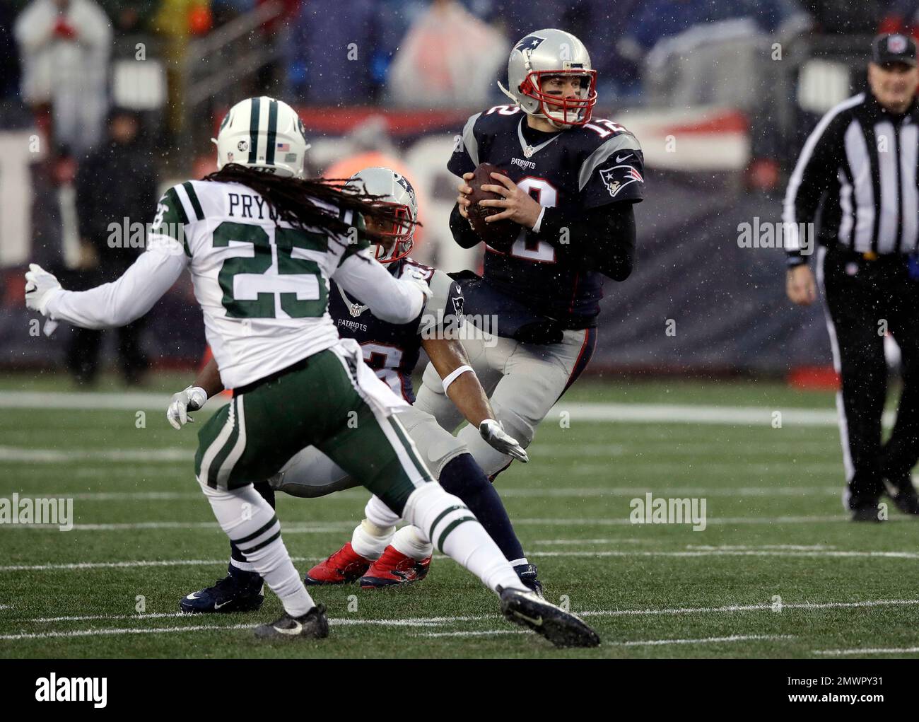 New England Patriots quarterback Tom Brady (12) passes under pressure ...