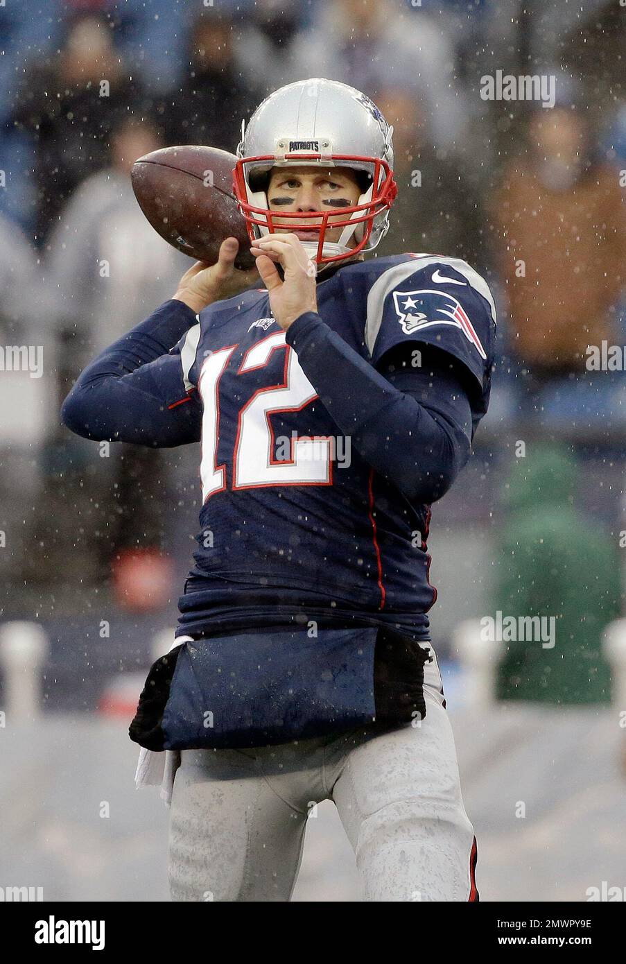 New England Patriots quarterback Tom Brady warms up in the rain before ...