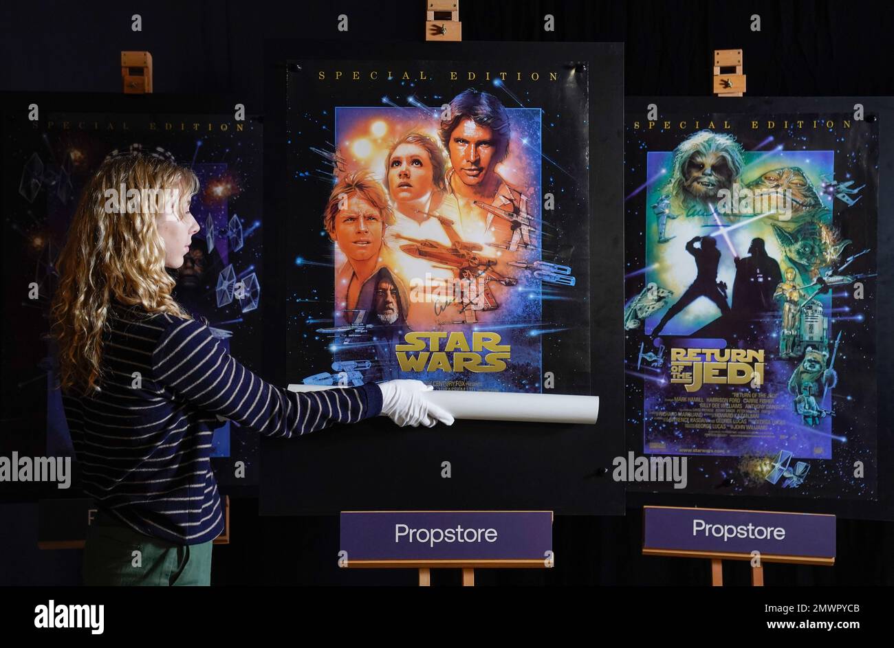 A Propstore employee adjusts one of a set of three Sir Alec Guinness ...