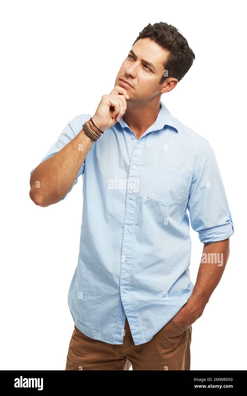 Choices. A thoughtful young man looking upwards while isolated on a ...