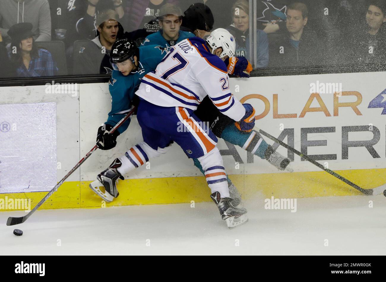 Edmonton Oilers' Milan Lucic (27) pushes San Jose Sharks' Kevin Labanc ...