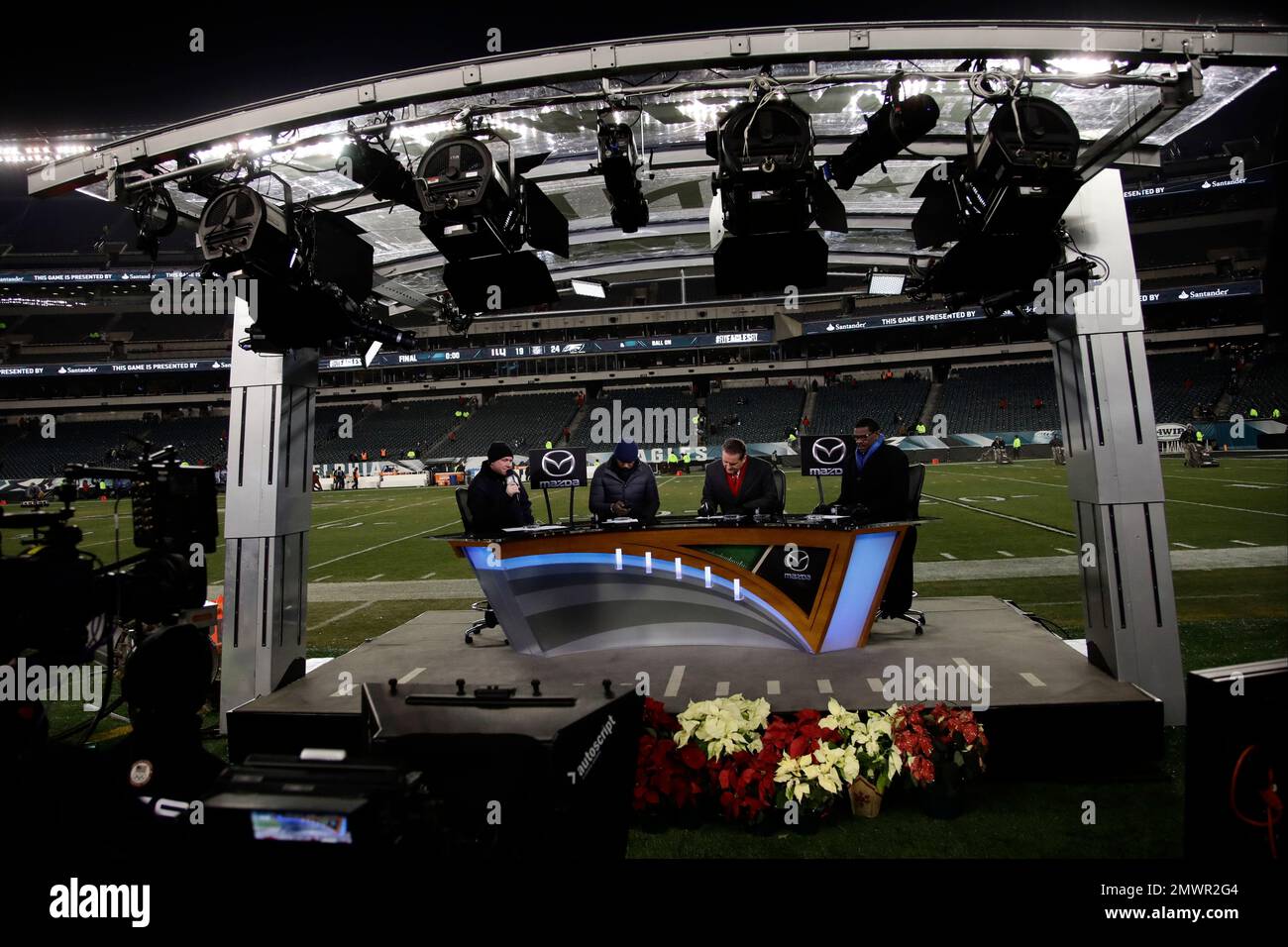 Television commentators prepare for a broadcast after an NFL football ...