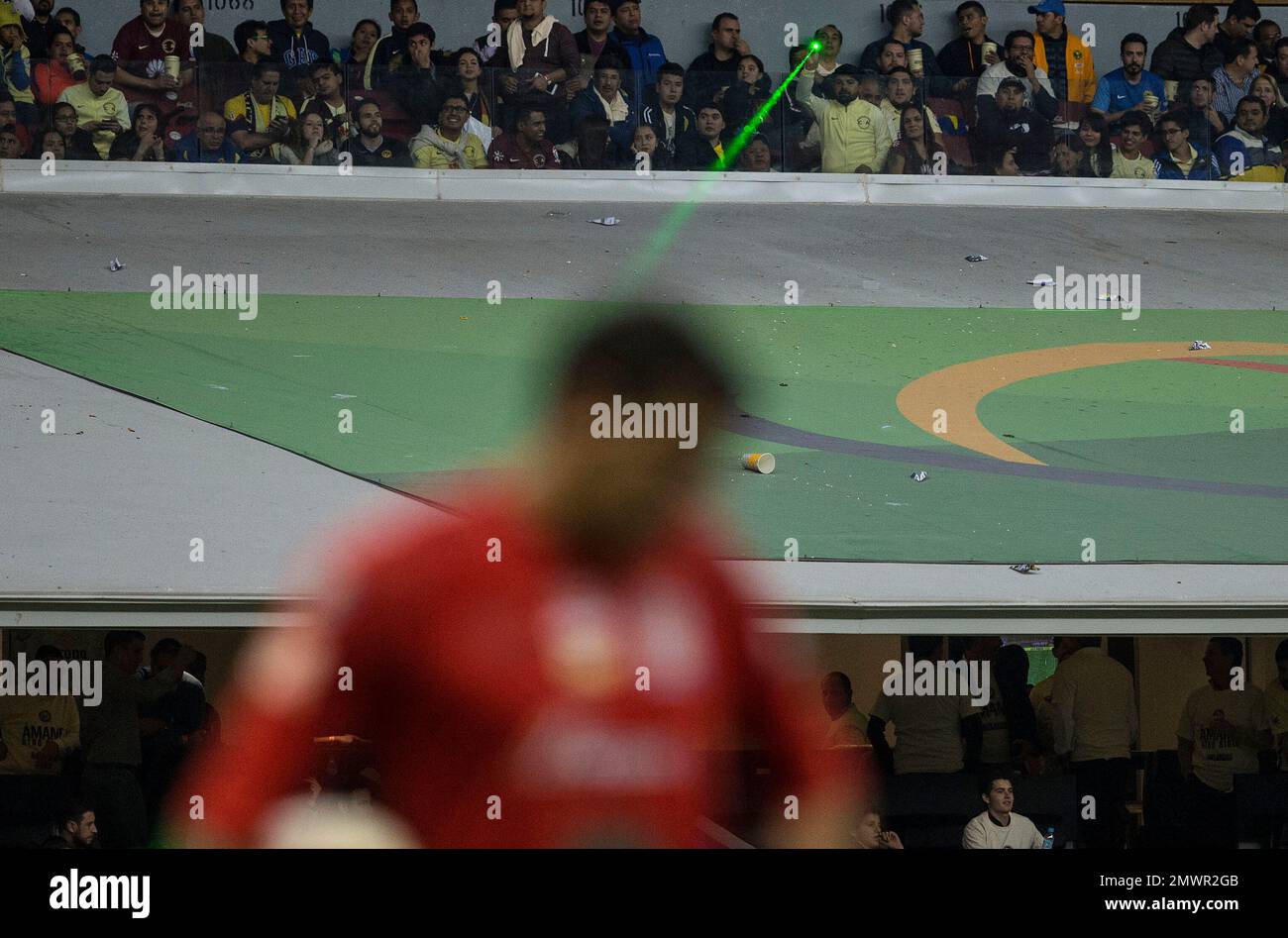 An America soccer fans directs a laser beam at Tigres goalkeeper Nahuel ...