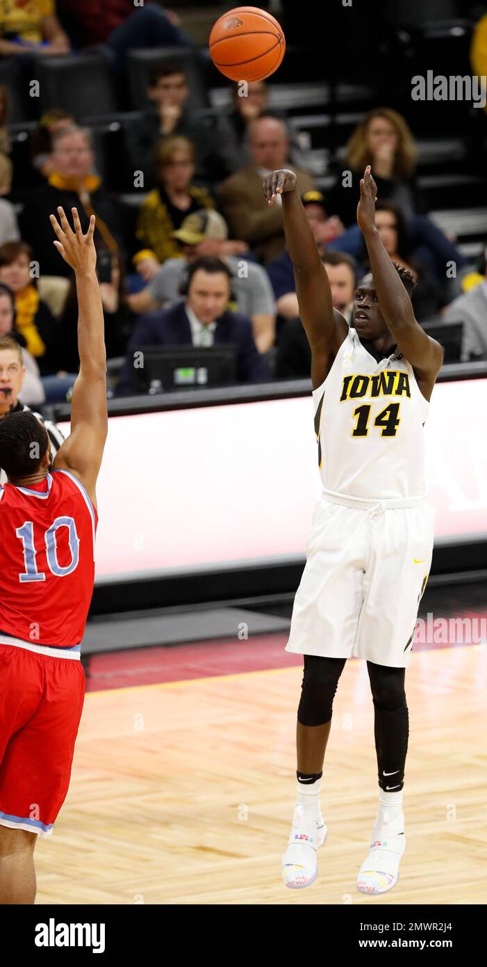 Iowa guard Peter Jok (14) shoots over Delaware State forward Kavon ...