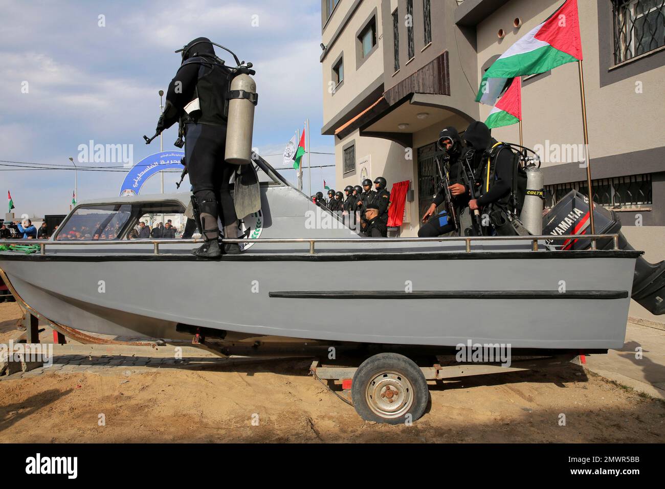 Palestinian Hamas naval security forces ride on top of a boat on a ...