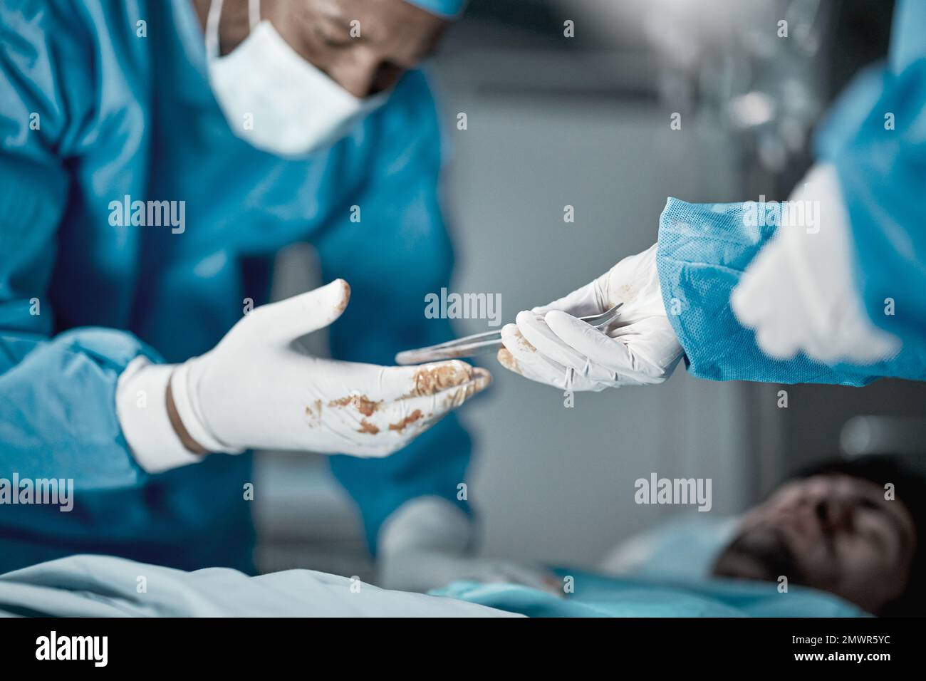 Hospital, surgery and hands of doctors with tweezers in operating room ...
