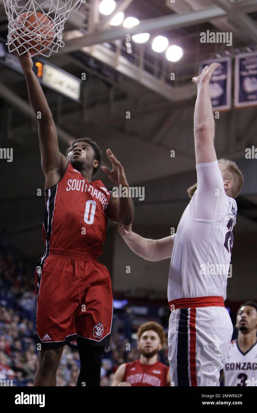 South Dakota guard Trey Dickerson (0) shoots while defended by Gonzaga ...