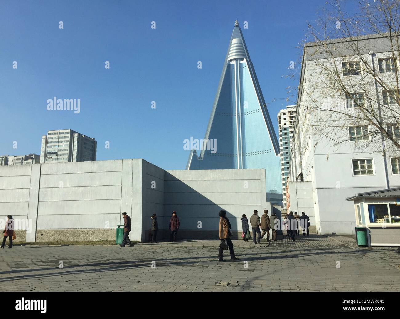 In this Dec. 11, 2016 photo, residents pass by the towering Ryugyong ...