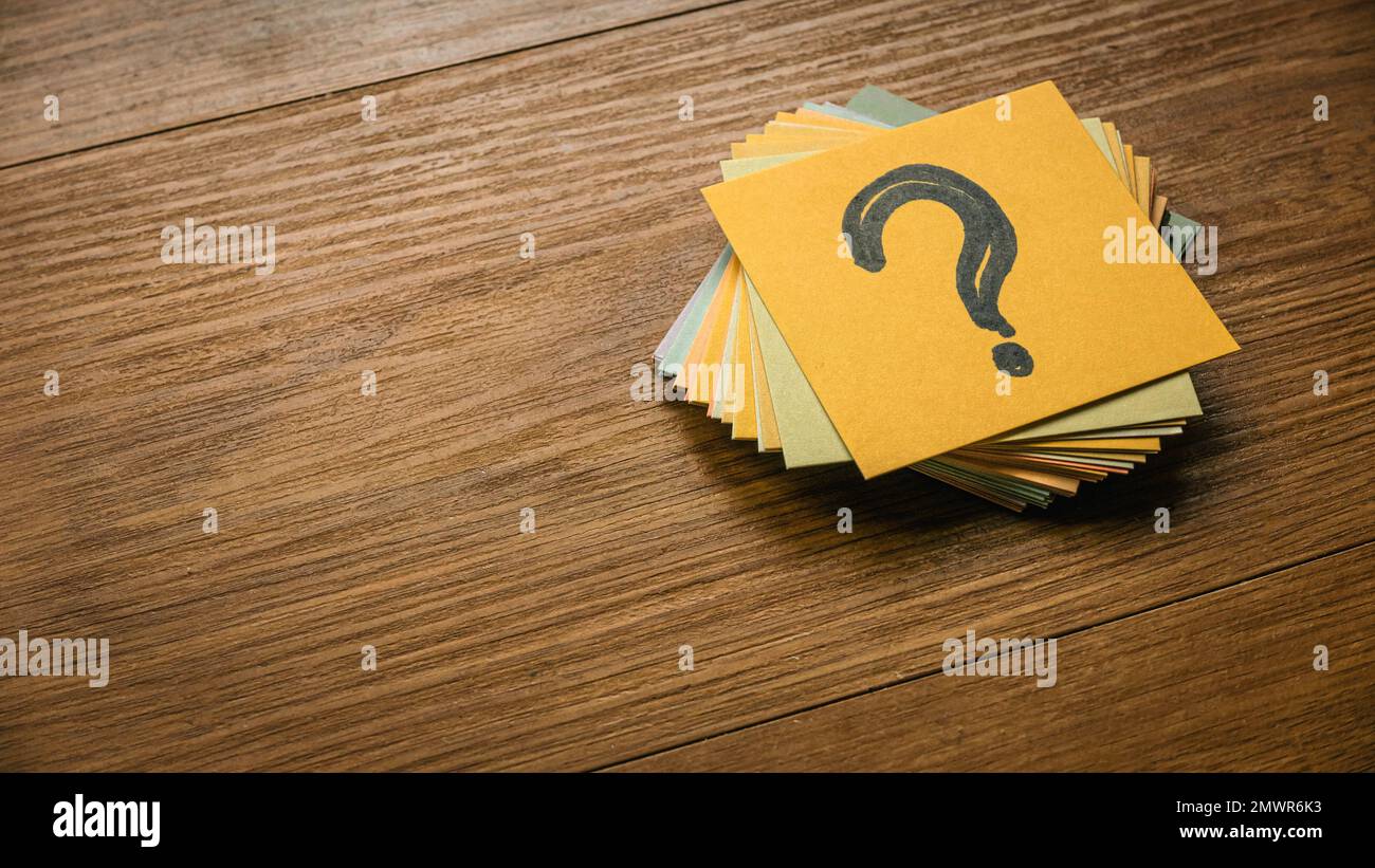 Questions and answers concept. A stack of paper with a paper on top ...