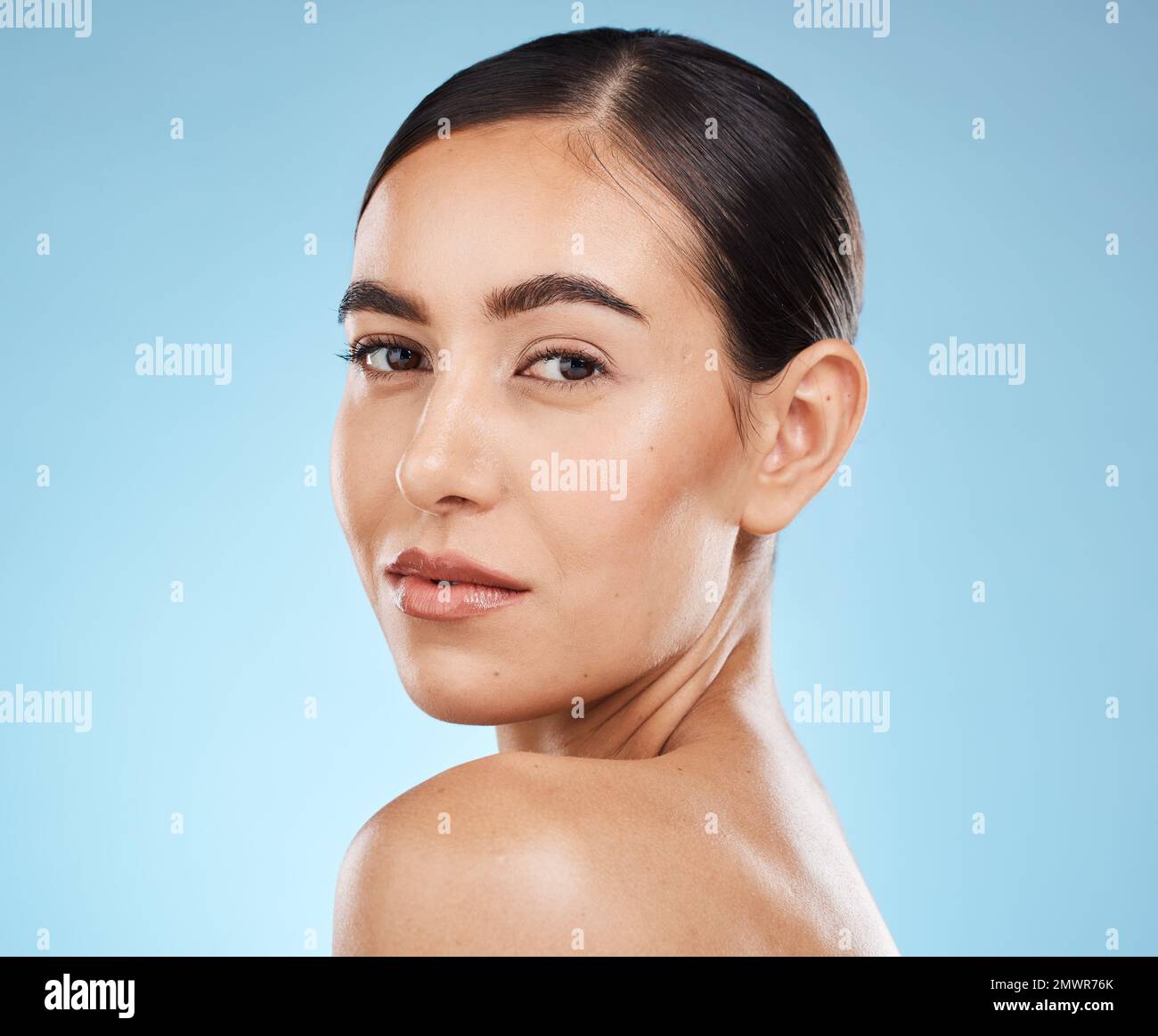 Portrait, shoulder and skincare with a model woman in studio on a blue ...