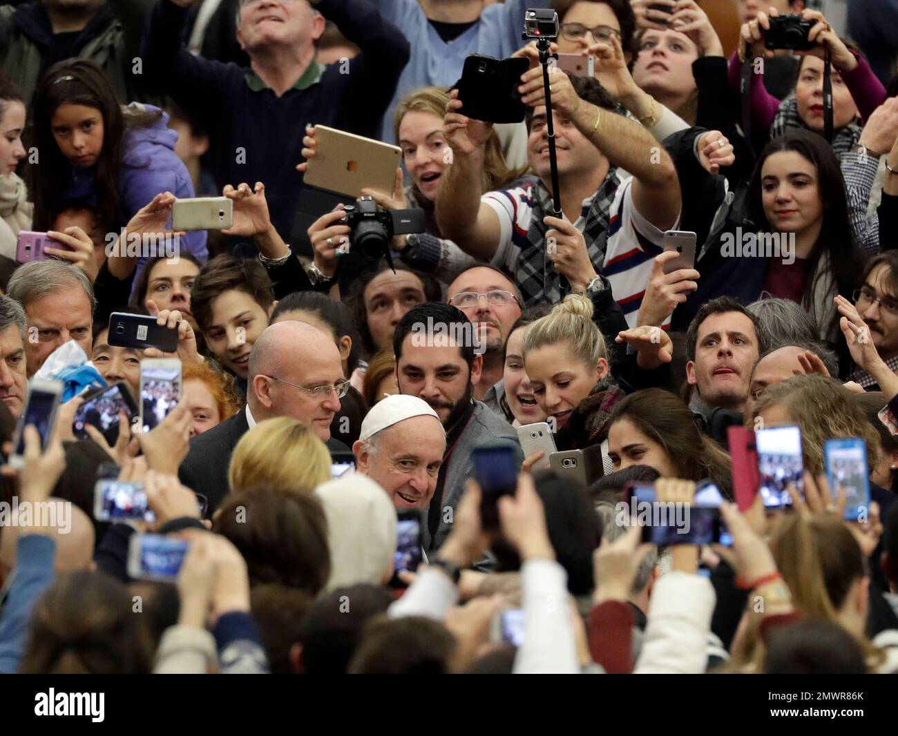People photograph and film Pope Francis with their smartphone as he ...