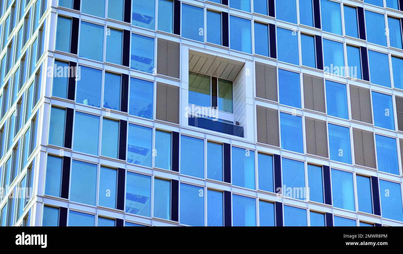 Abstract closeup of the glass-clad facade of a modern building covered ...