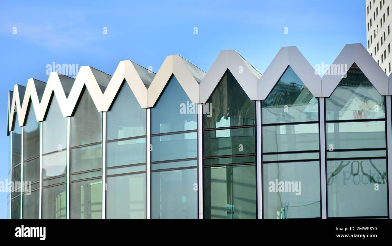 Abstract closeup of the glass-clad facade of a modern building covered ...