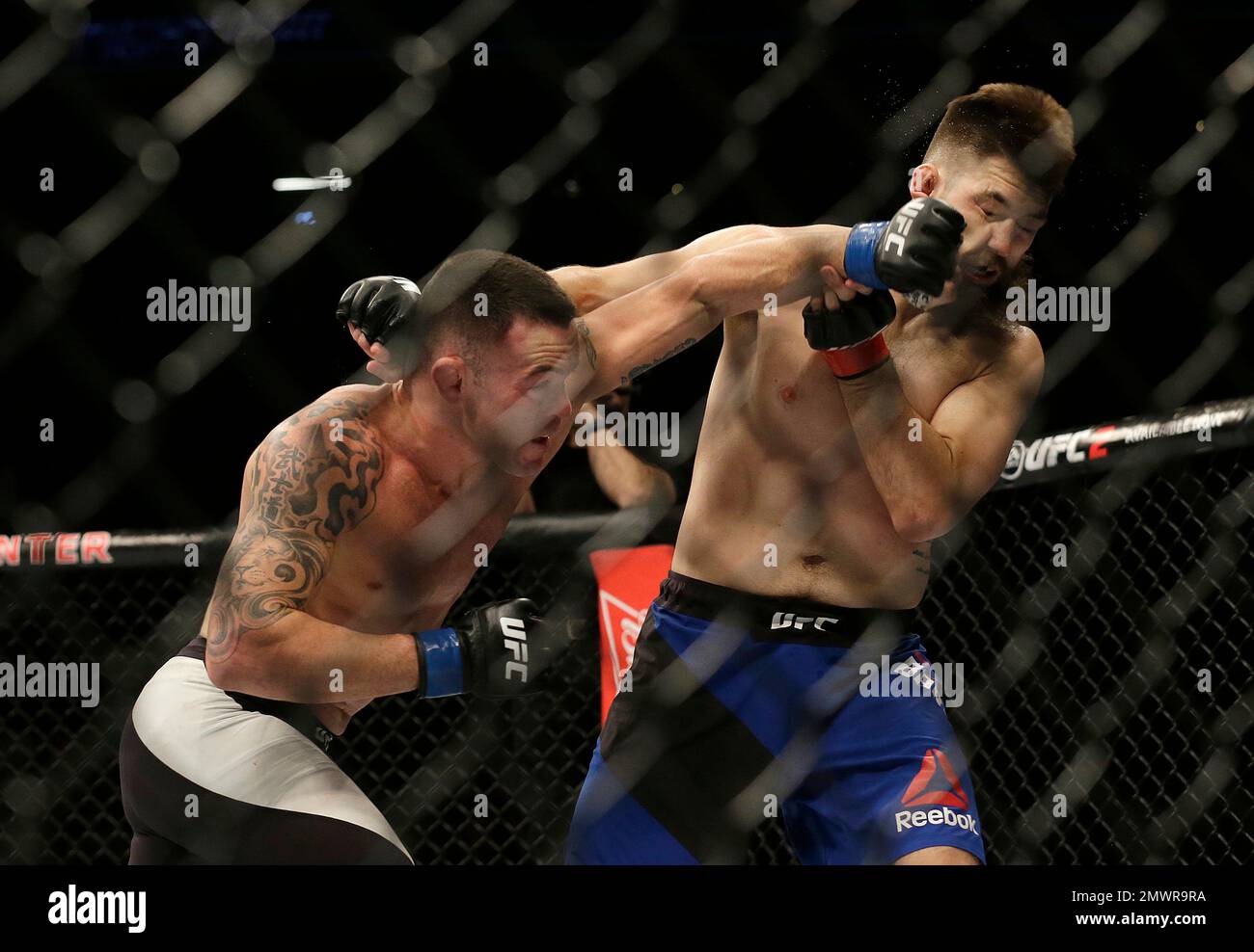 Colby Covington, left, punches Bryan Barberena during a UFC Fight Night ...