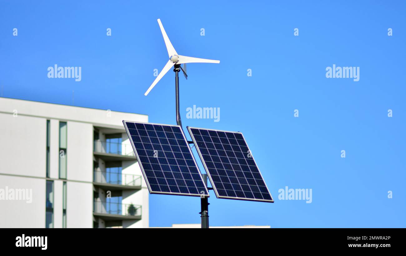 Solar panel and wind turbine against blue sky Stock Photo - Alamy