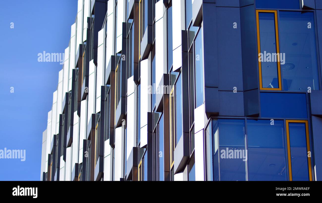 Glass building with transparent facade of the building and blue sky ...