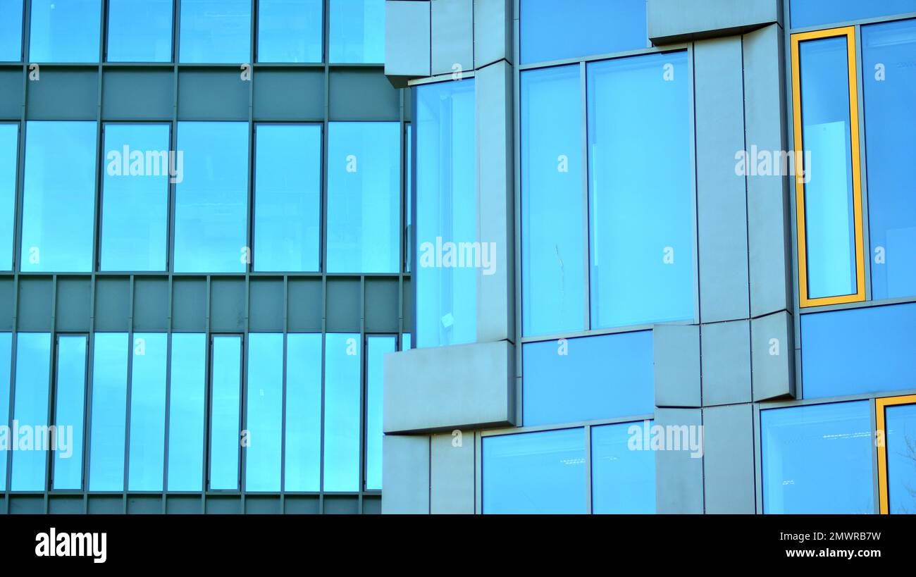 Glass building with transparent facade of the building and blue sky ...