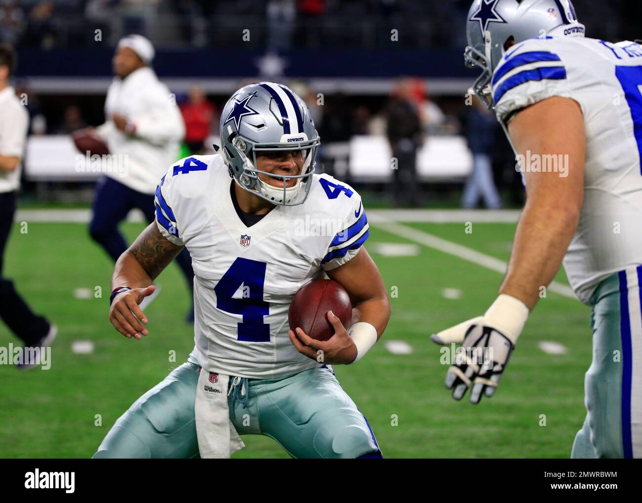 Dallas Cowboys' Dak Prescott (4) jokes with Doug Free, right, during ...