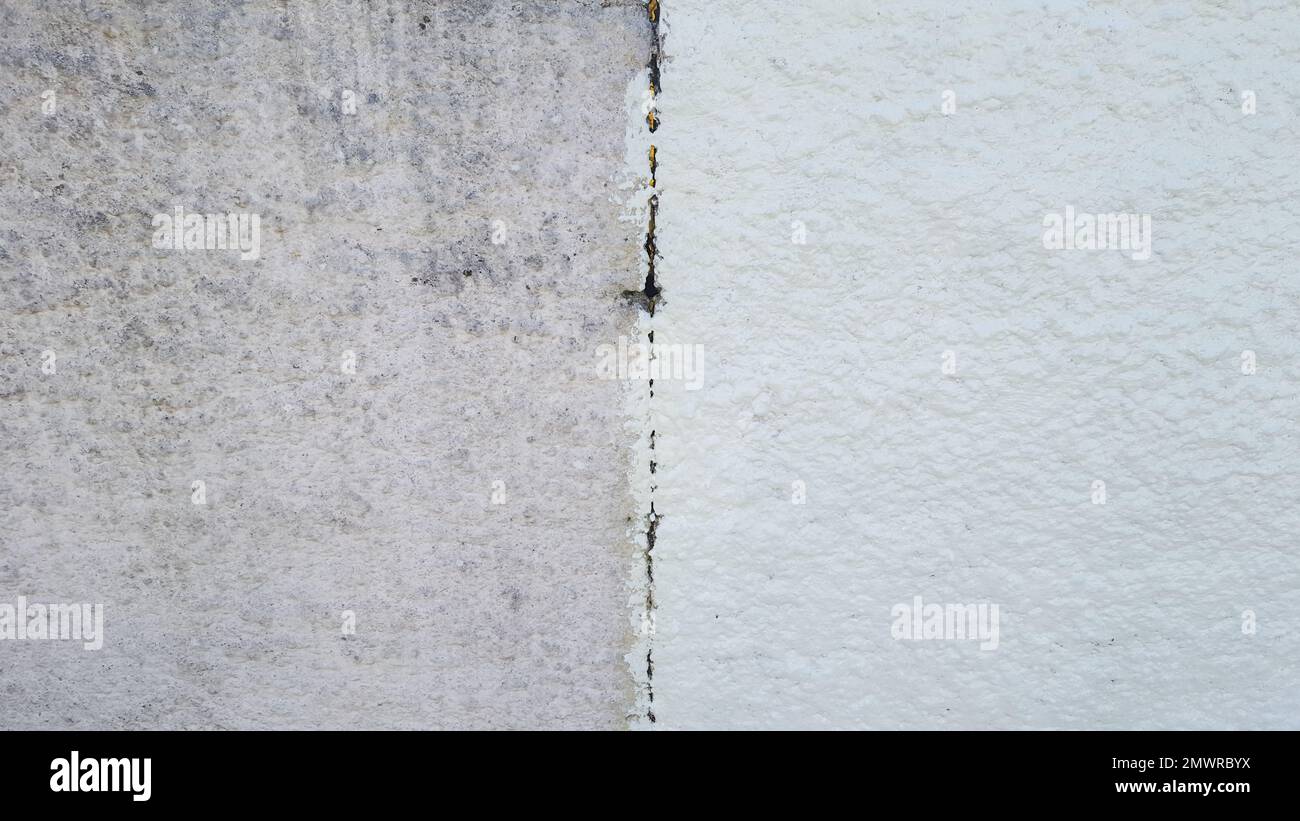 wash cleaned wall house facade and a dirty one in a city town, before ...