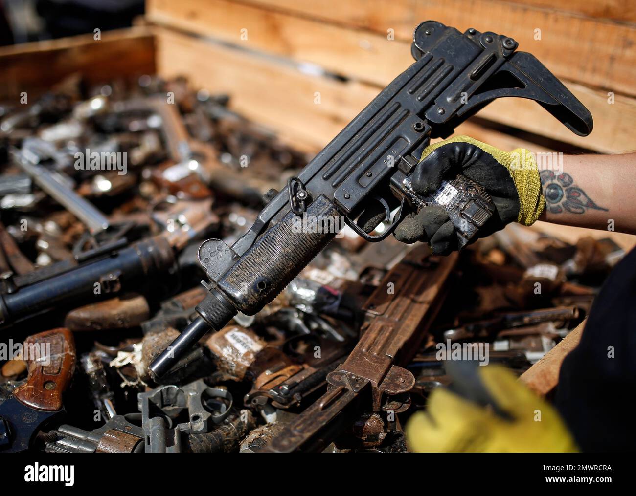 Confiscated weapons sit in a wooden crate before they are destroyed as ...