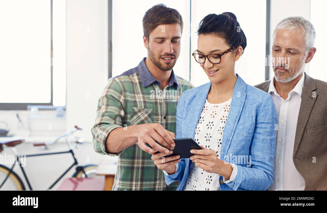 Showing the guys how its done. a group of designers talking together ...