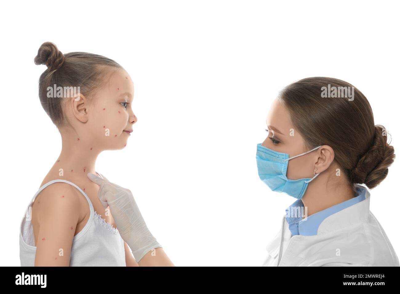 Doctor examining little girl with chickenpox on white background ...