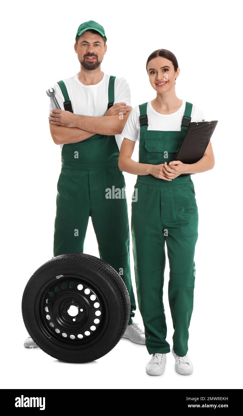 Full length portrait of professional auto mechanics on white background ...