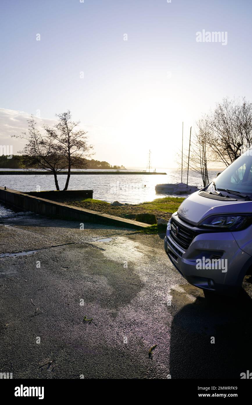 camper van rv by the lake in sunset vanlife Stock Photo - Alamy