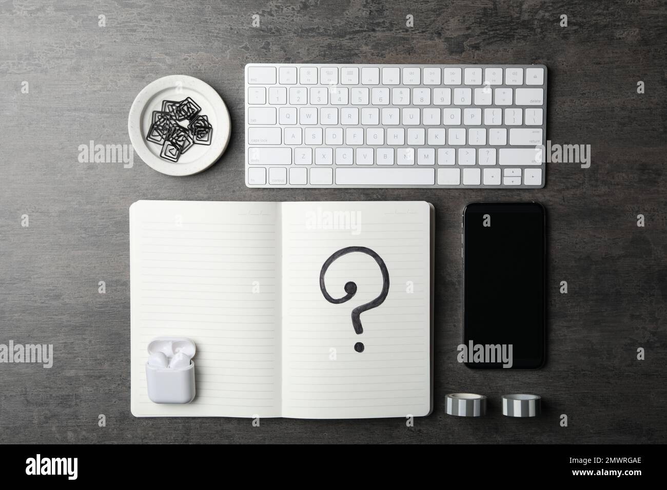 Notebook with question mark, smartphone and keyboard on grey table, flat lay Stock Photo - Alamy