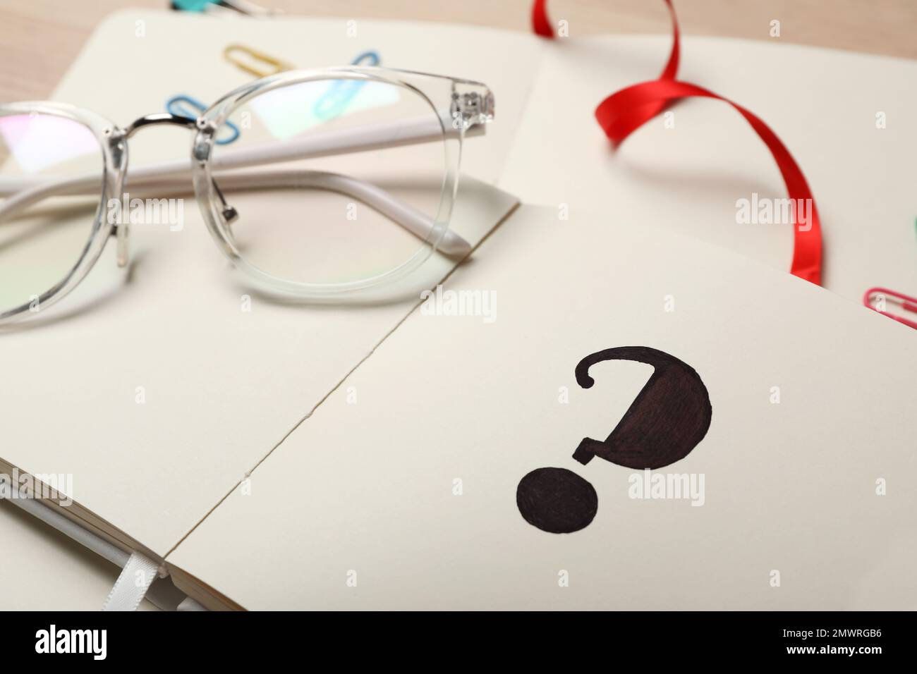 Question mark written in notebook and eyeglasses, closeup Stock Photo ...