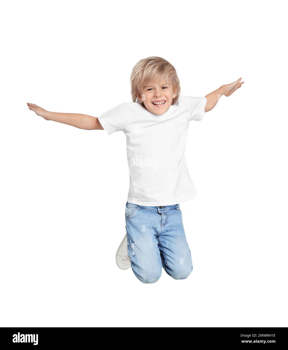 Happy little boy jumping on light grey background Stock Photo - Alamy