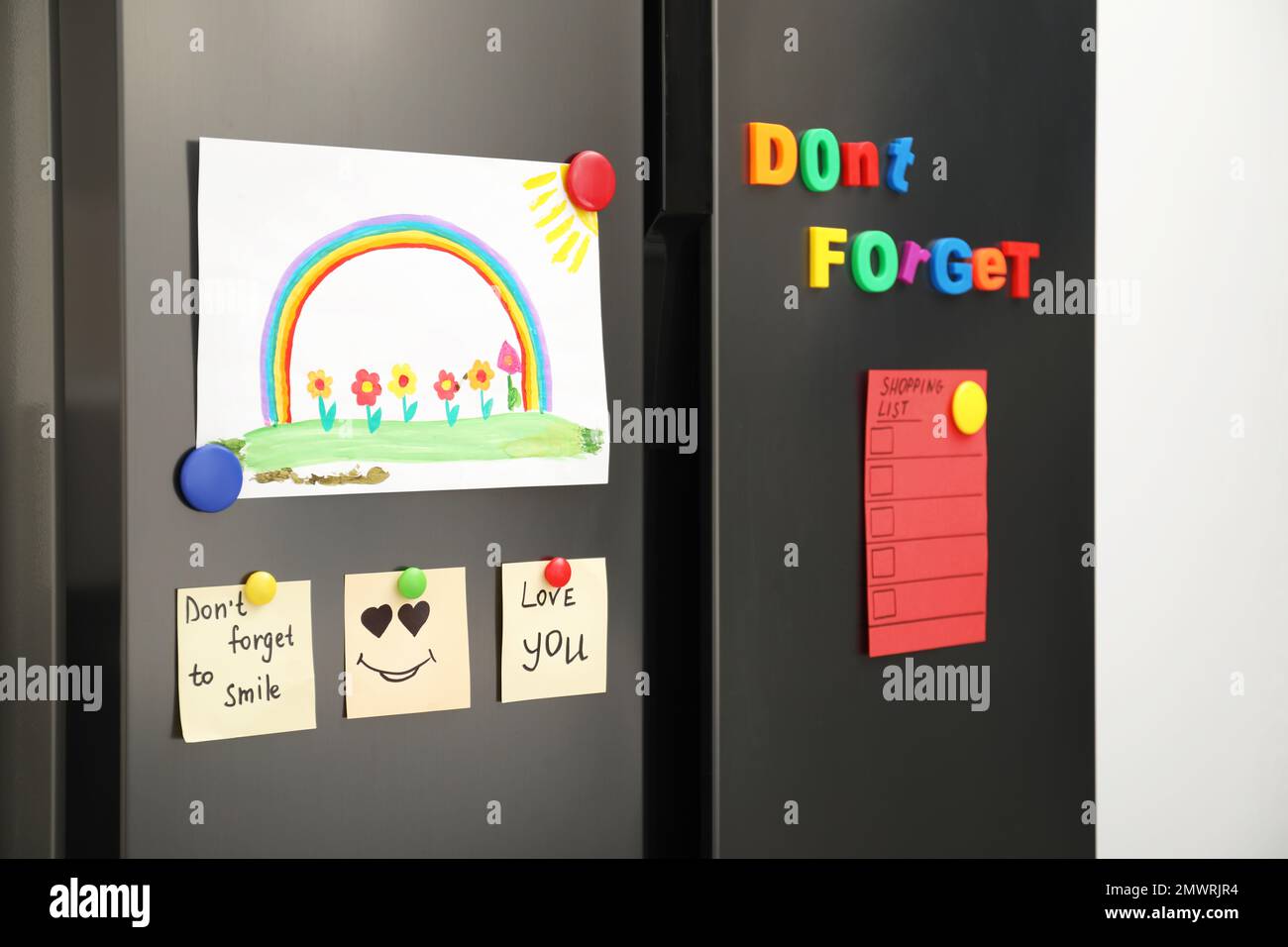 Modern refrigerator with child's drawing, notes and magnets Stock Photo ...