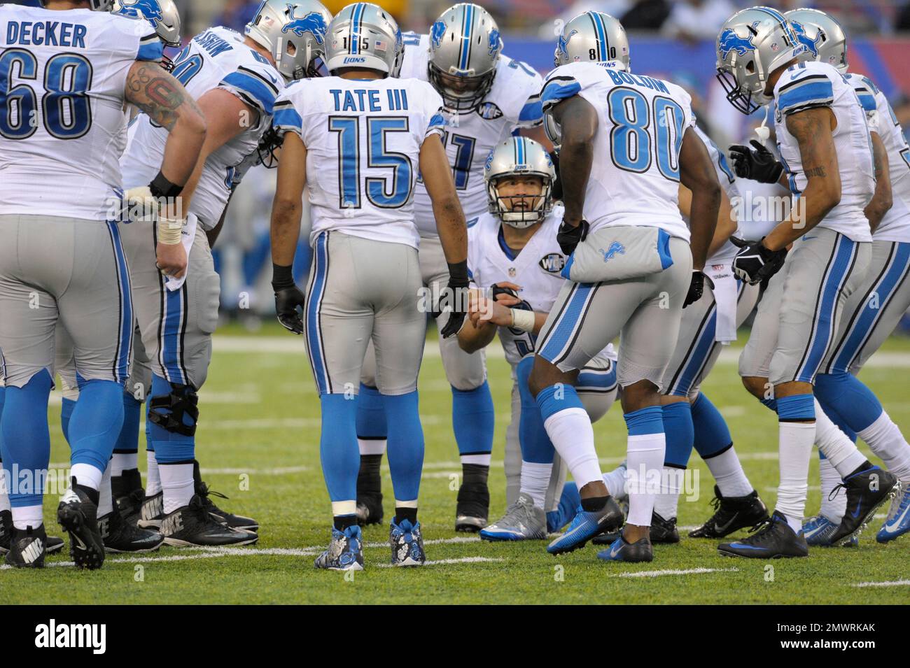 Detroit Lions quarterback Matthew Stafford, center, talks to teammates ...
