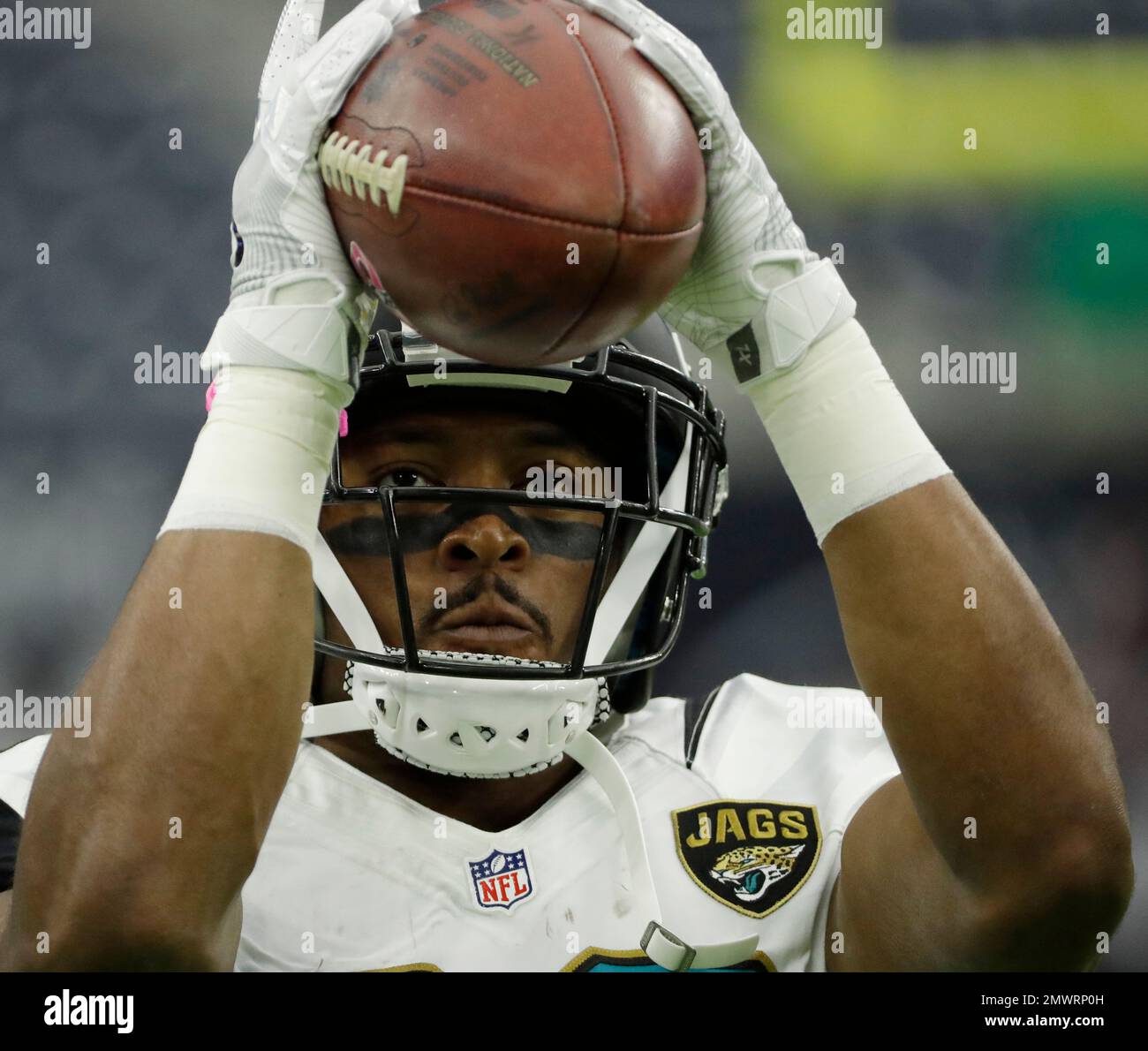 Jacksonville Jaguars running back Corey Grant is shown an NFL football ...