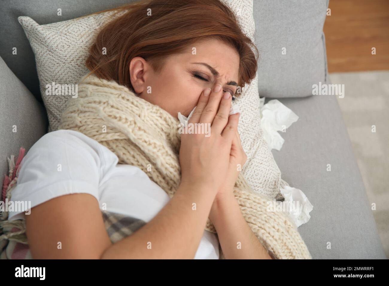 Sick woman lying on sofa at home. Influenza virus Stock Photo - Alamy