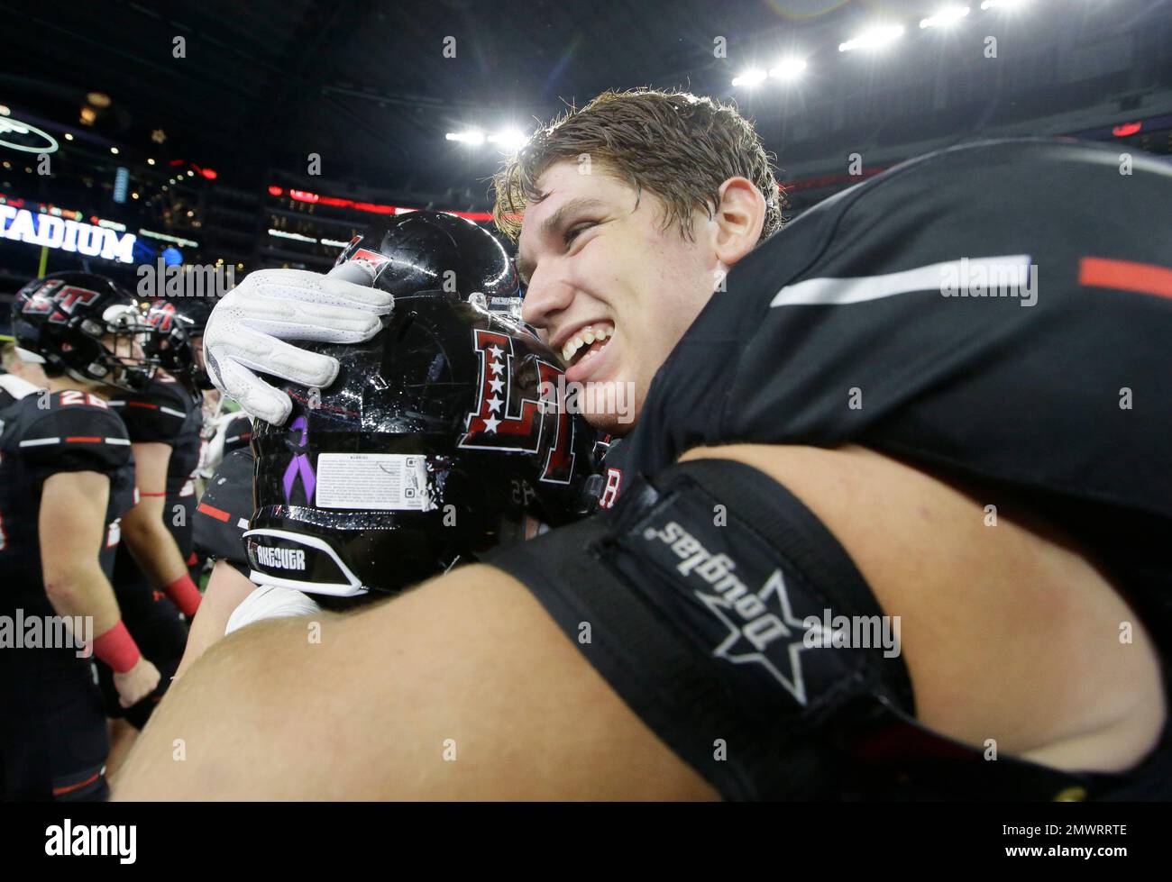 Lake Travis offensive lineman Brenden Jaimes, right, hugs teammate ...