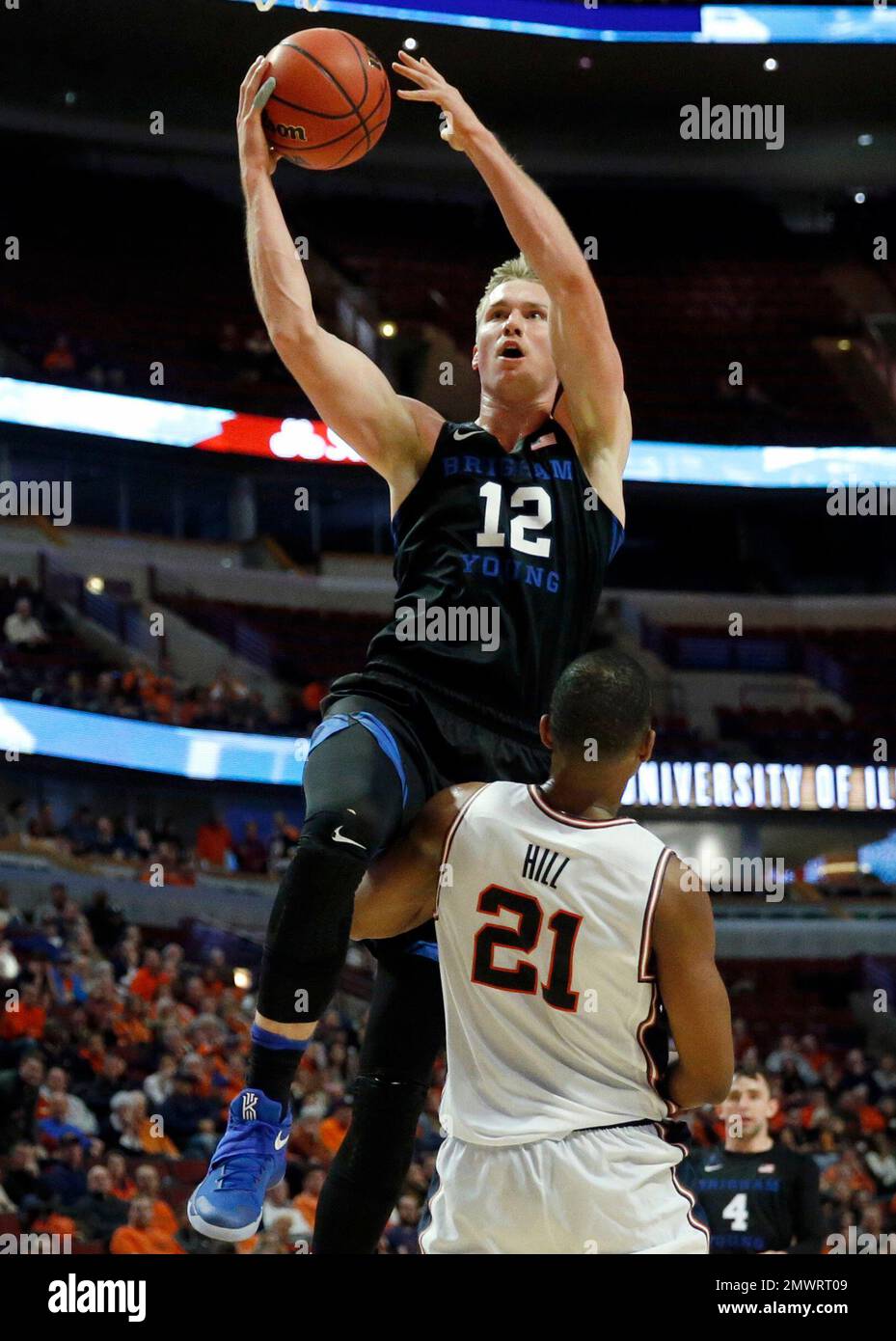 BYU forward Eric Mika, top, drives to the basket against Illinois guard ...